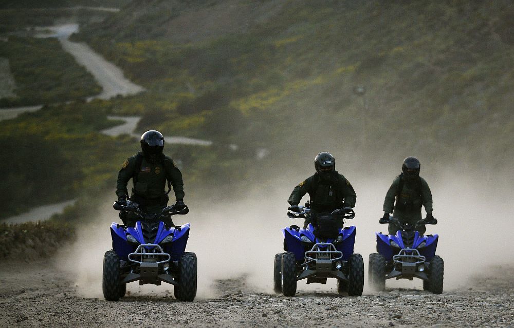 DOCU_GRUPO U.S. Border Patrol agents ride their ATVs on patrol along ...